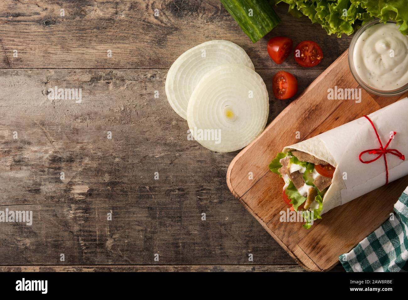 Doner kebab or shawarma sandwich on wooden table. Top view. Copy space ...