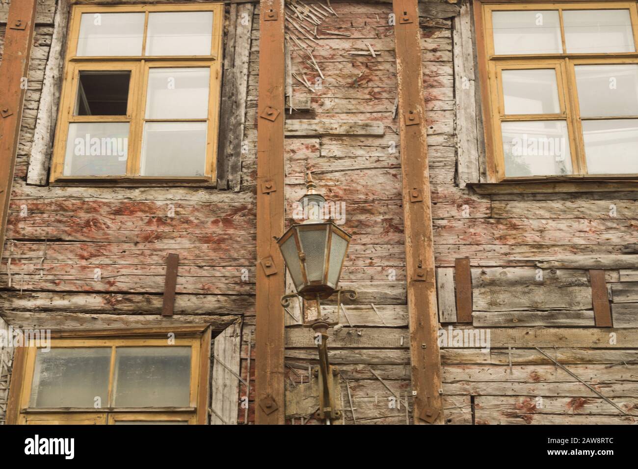 Windows of the old wooden house. wooden plank wall with windows and ...