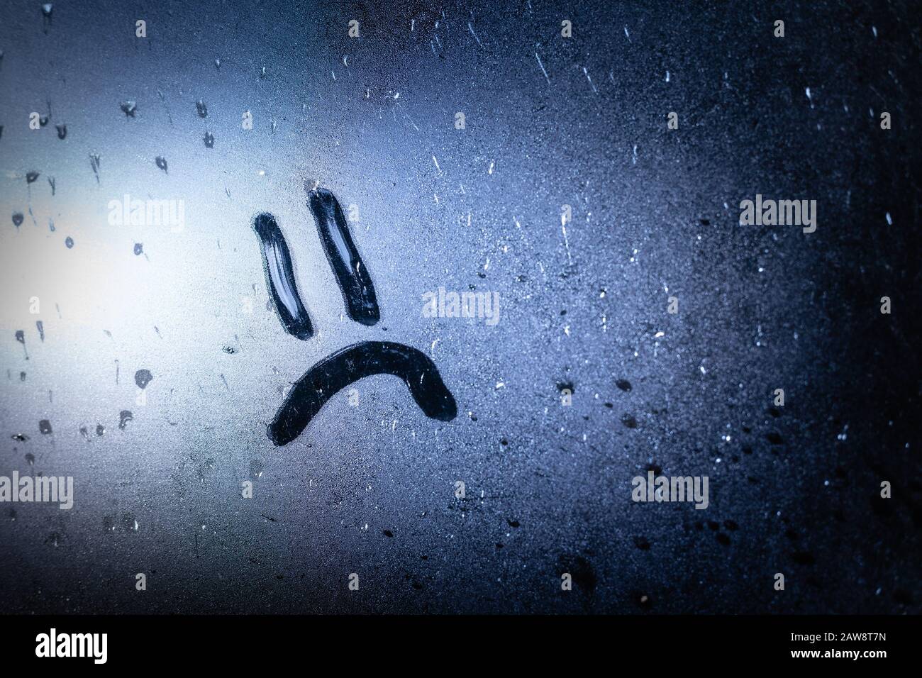 Window with raindrops. Stock photo drawing the "sad smiley" on wet ...