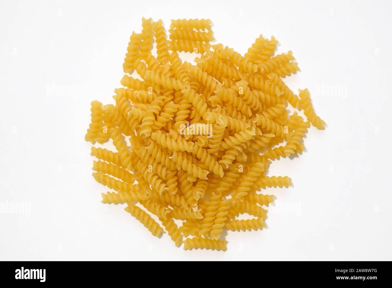 Spiral pasta on a white background. Uncooked italian pasta top view ...