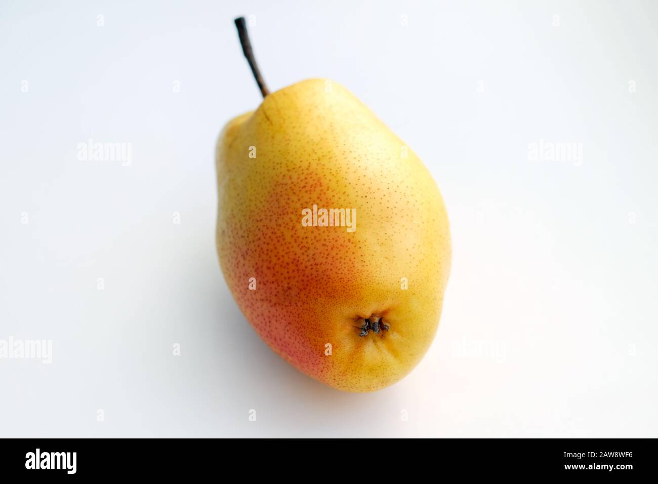 Yellow pear with a red side on a white background. Ripe hard pear in ...