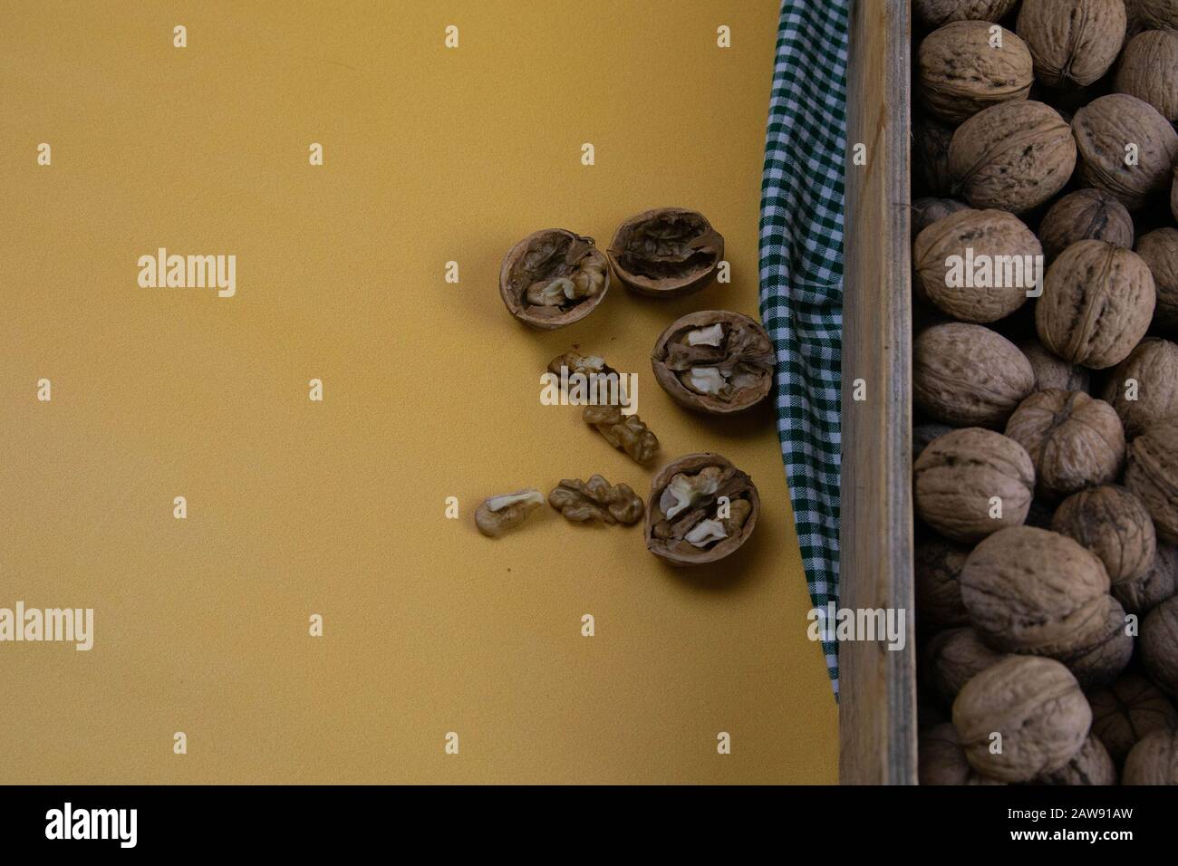 Whole walnuts in shells in a box, walnuts kernels. next to the box is a ...