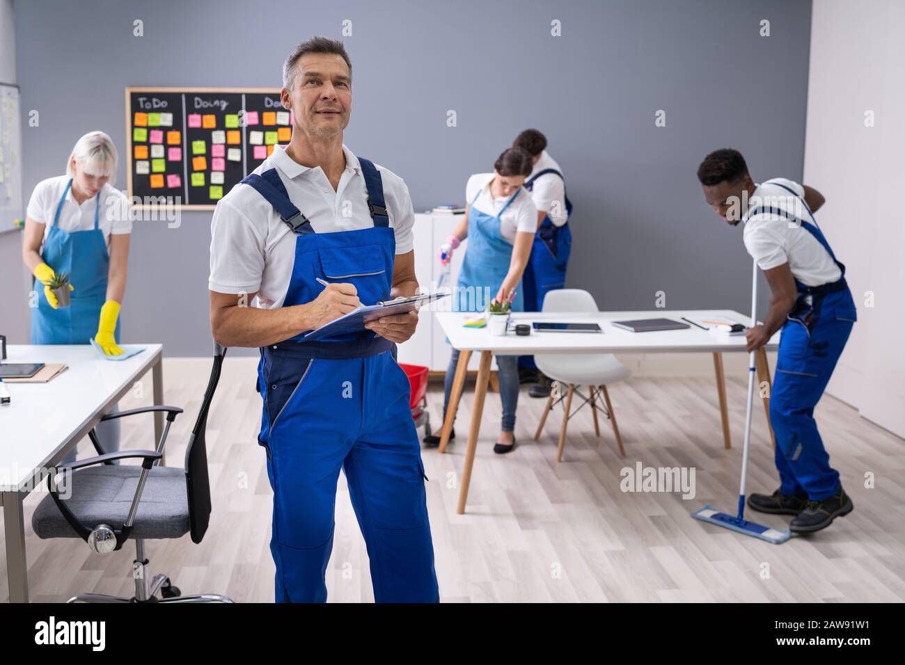 Janitor With His Team Cleaning Modern Office Stock Photo - Alamy