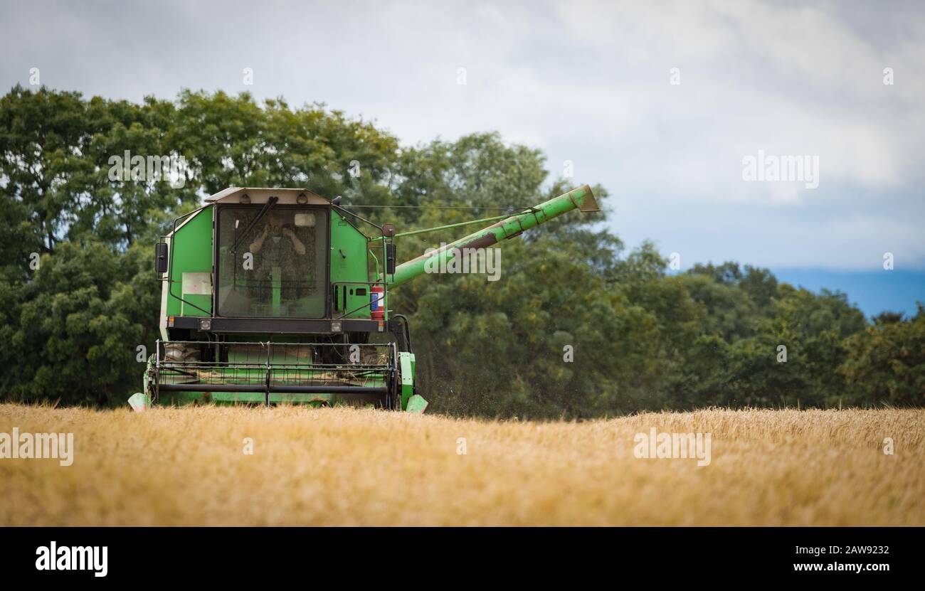 combine harvester harvesting crops in a field in rural Ireland Stock ...