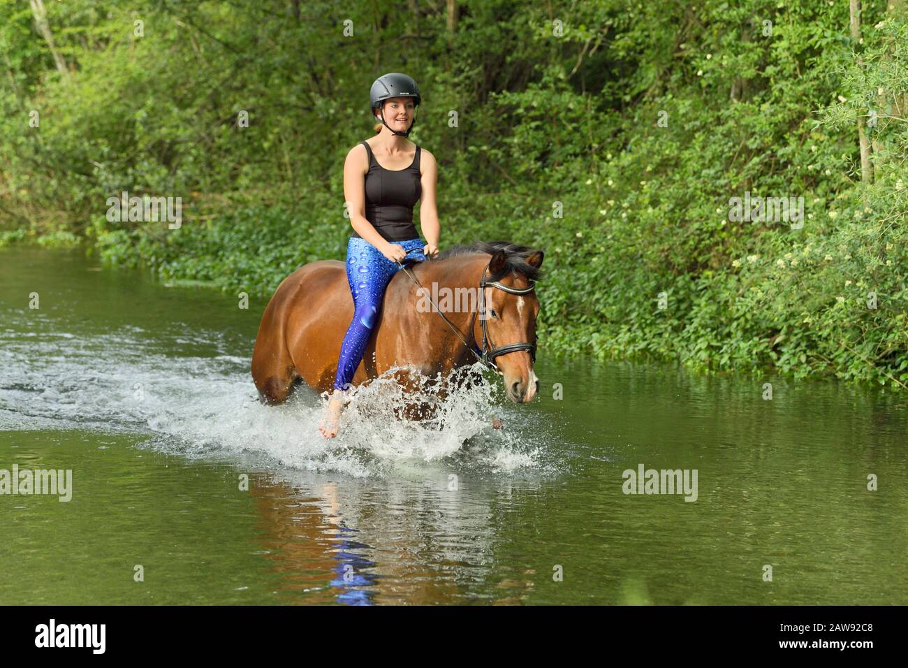 Young woman riding bareback on a pony in a stream Stock Photo - Alamy