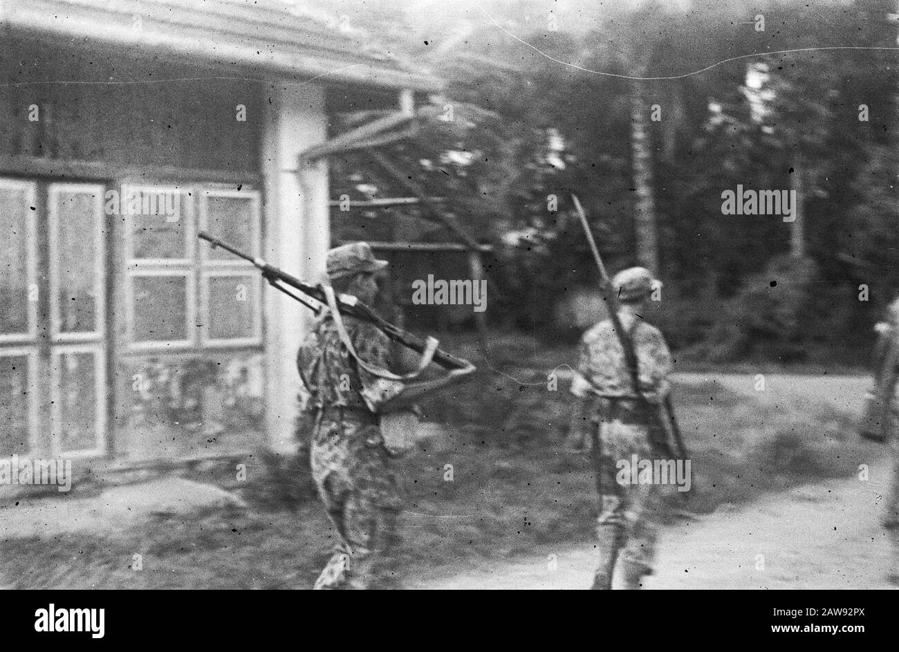 KNIL soldiers. One has put a bayonet on his rifle, the other carrying a ...