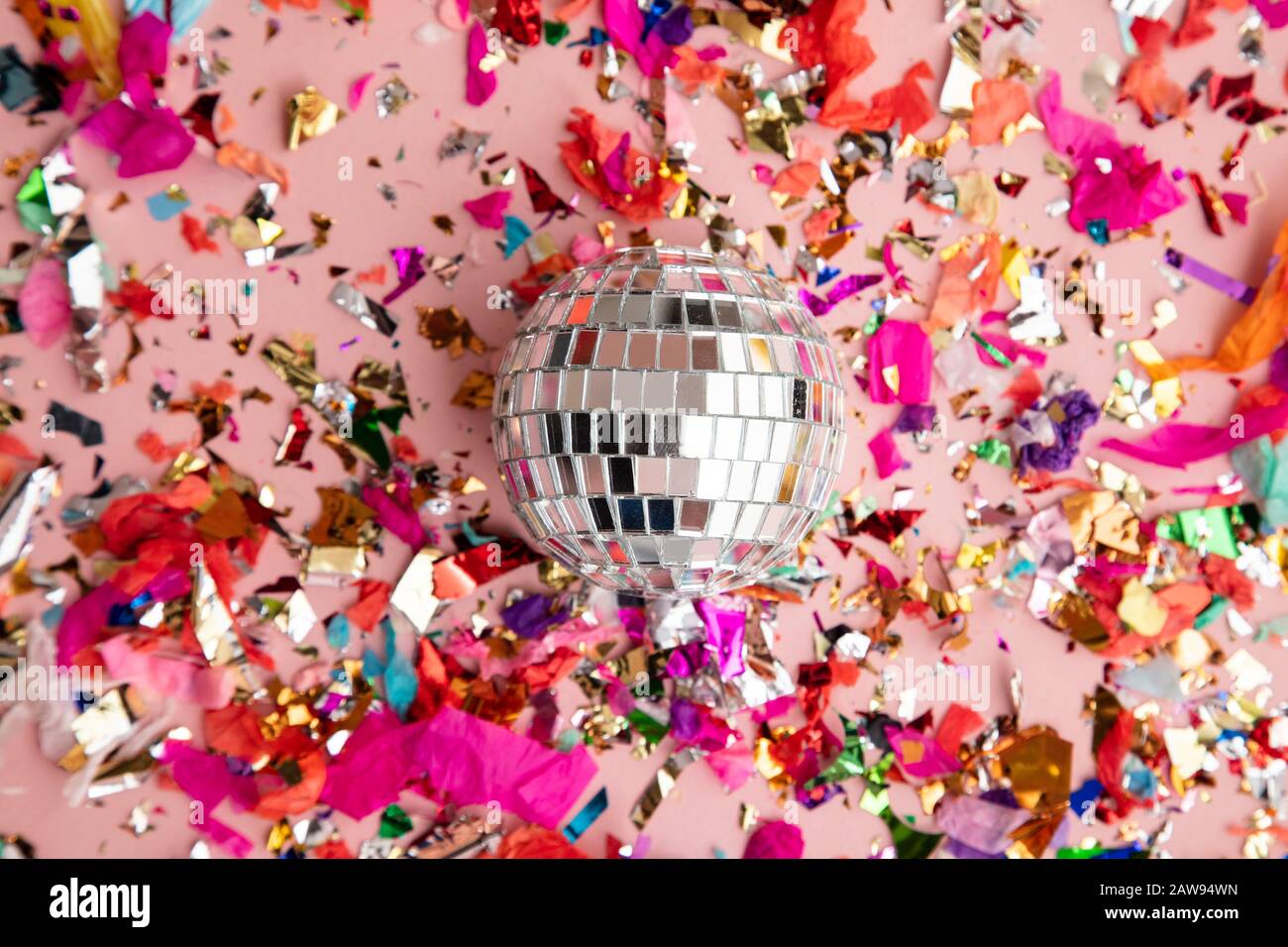 Disco mirror ball on bright party confetti background Stock Photo - Alamy