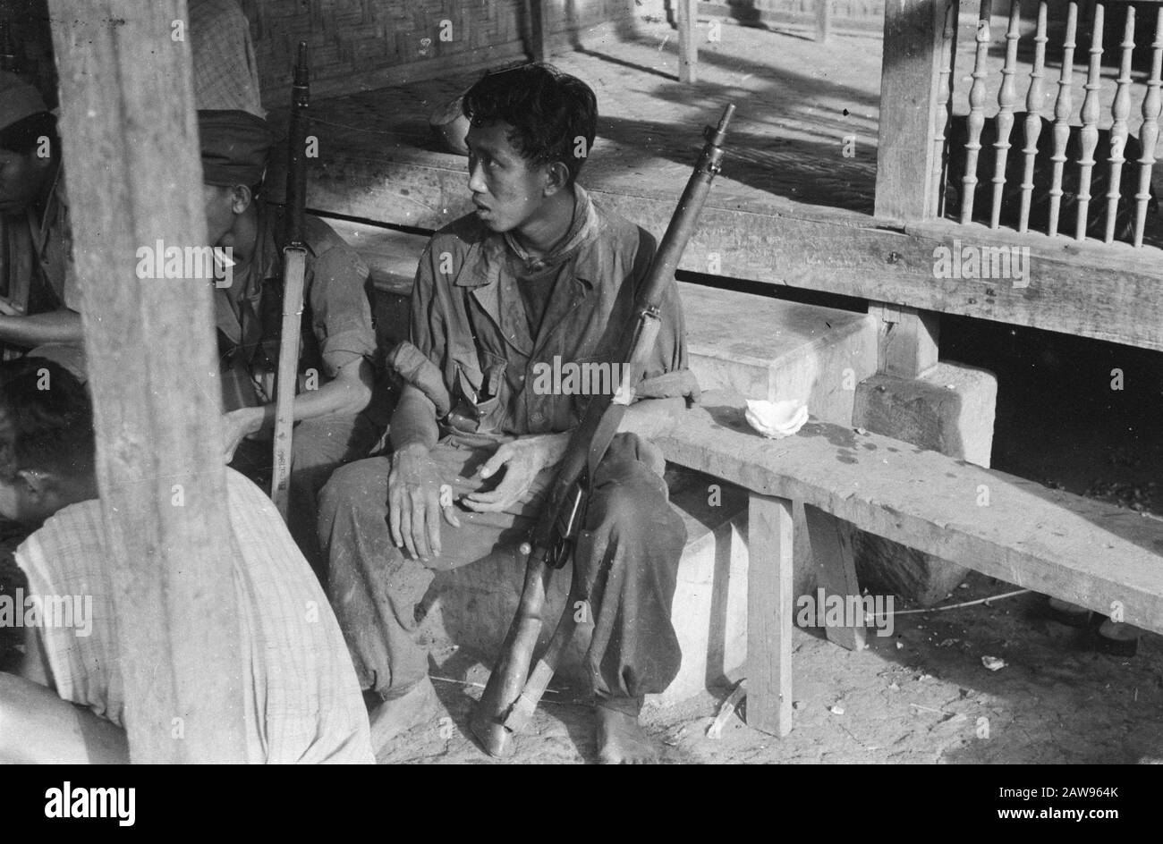 KNIL soldiers sitting on the porch of a house Date: 01/01/1947 Location ...