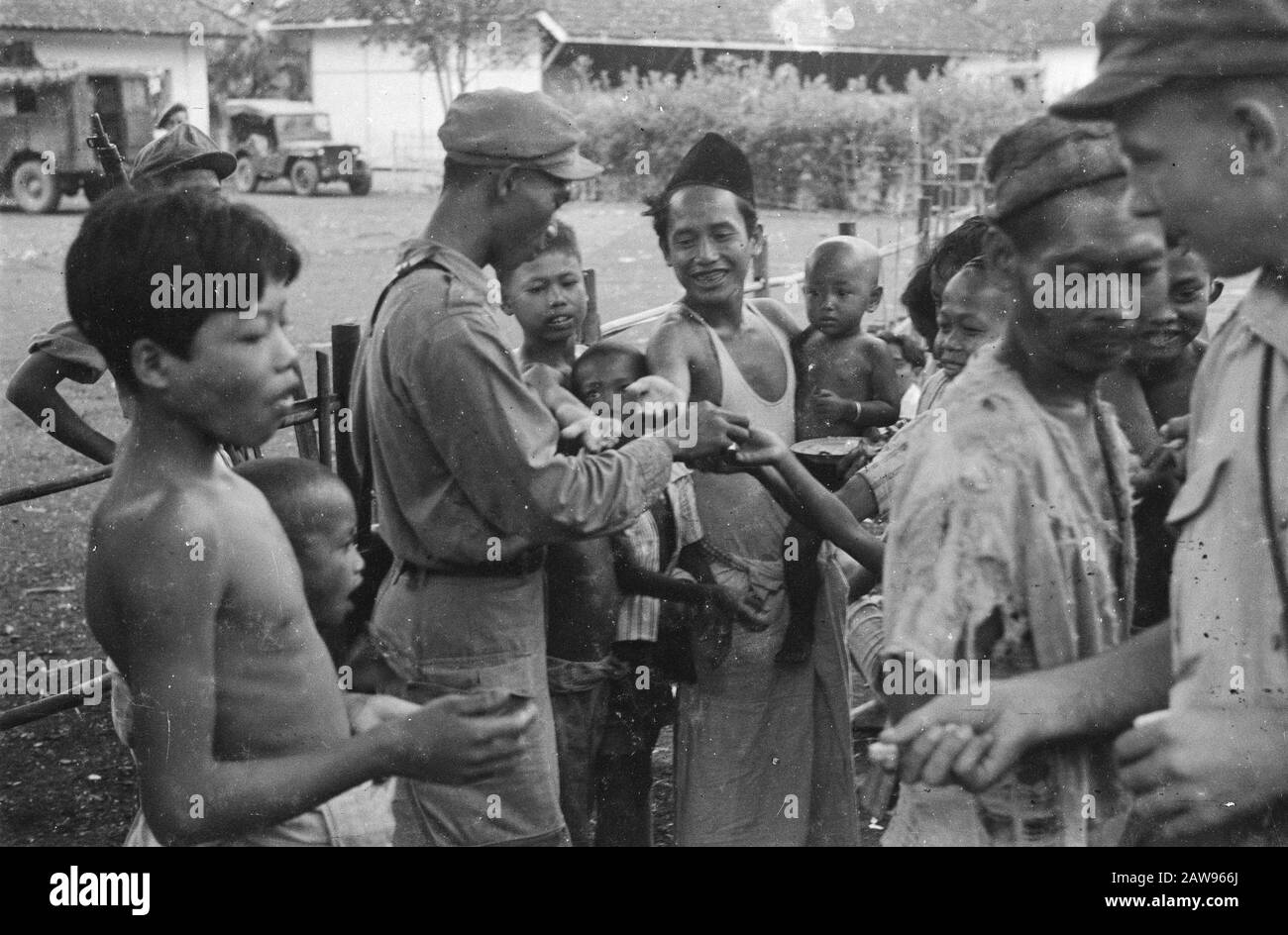 KNIL soldiers sharing candy or drugs from? Date: 01/01/1947 Location ...