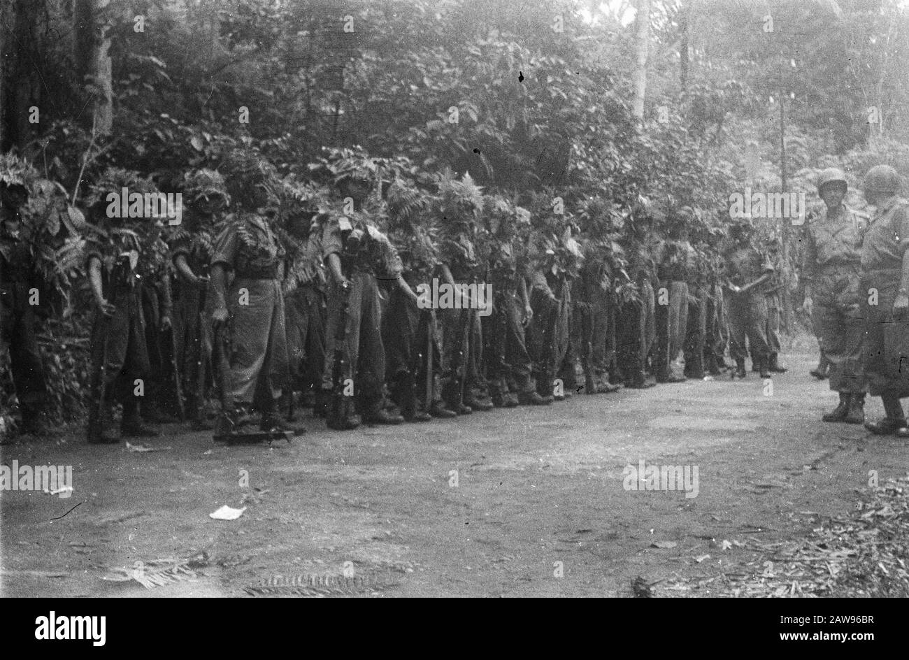 KNIL soldiers with heavy camouflage stand to Date: 01/01/1947 Location ...
