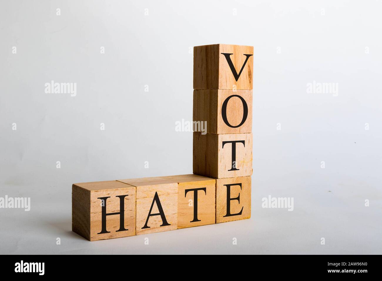 Wooden cubes with lettering spelling Vote Hate. Concept to vote for or ...