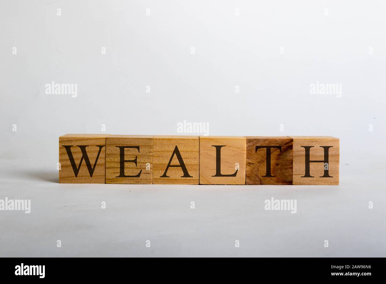 Wooden cubes with lettering spelling Wealth. Business or life concept ...