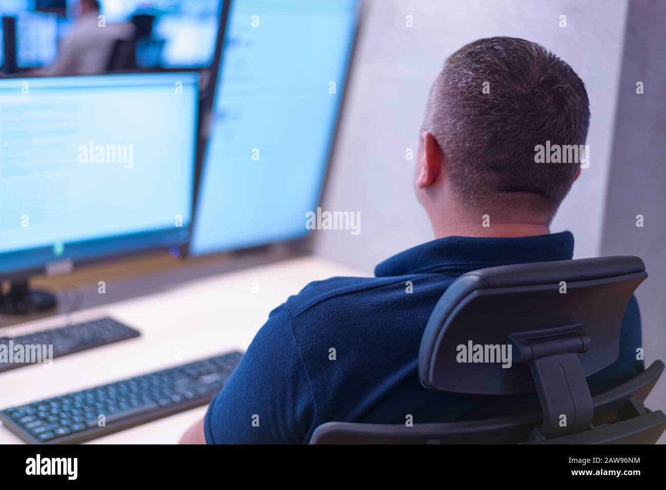 Security guard monitoring modern CCTV cameras in surveillance room ...