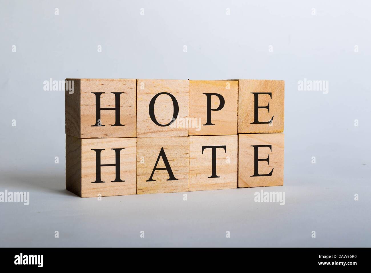 Wooden cubes with lettering spelling Hope Hate. Concept that Hope beats ...