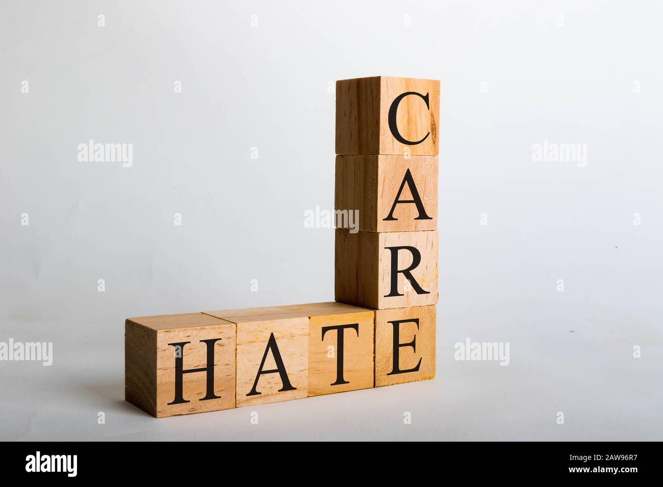 Wooden cubes with lettering spelling Care Hate. Concept that Care beats ...