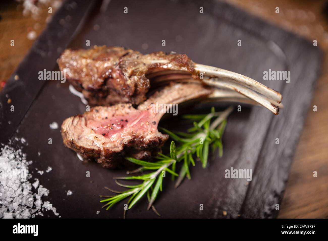 Grilled lamb chops served with a branch of rosemary Stock Photo - Alamy