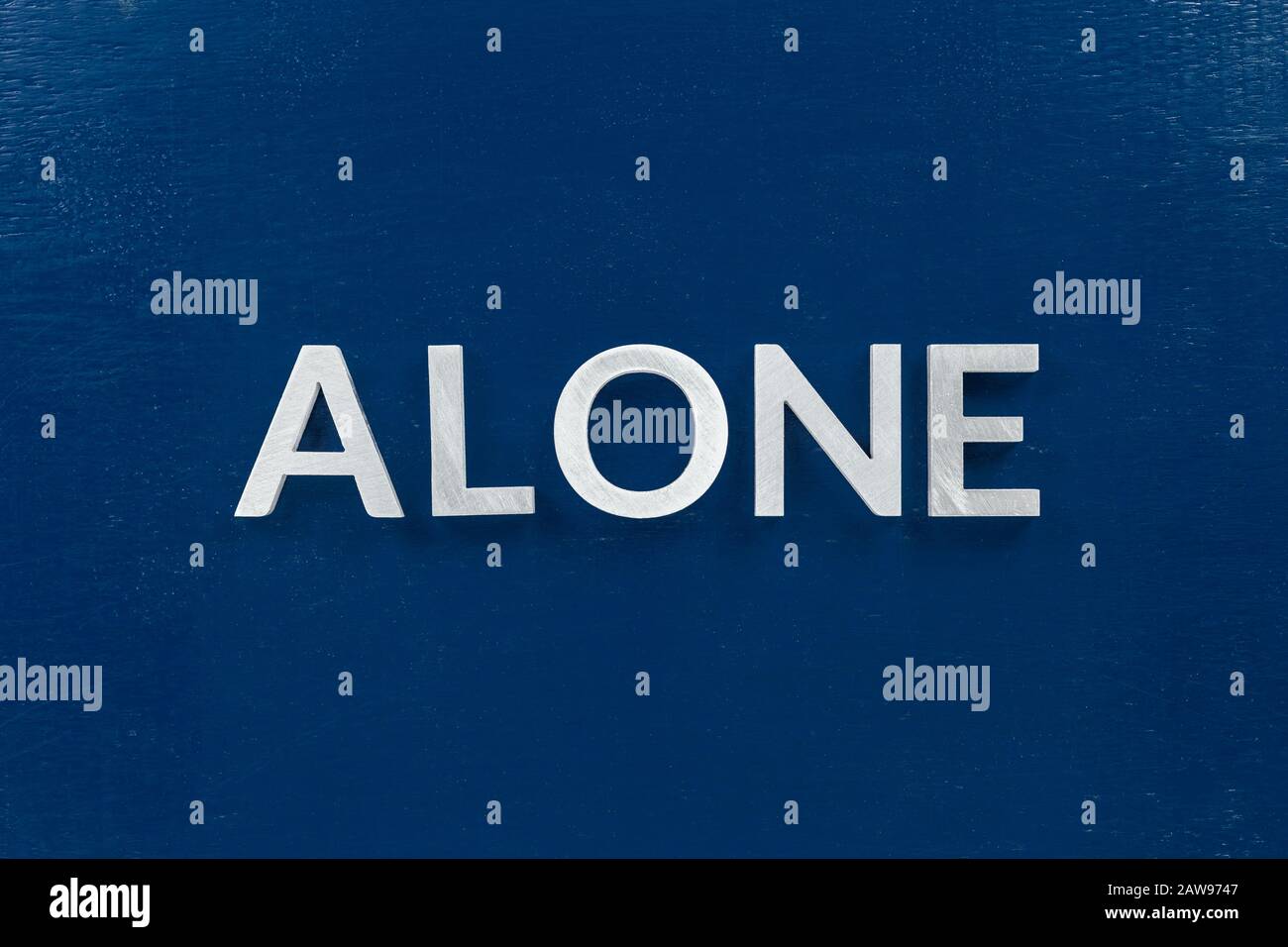 The word alone laid with silver metal letters in center of painted ...