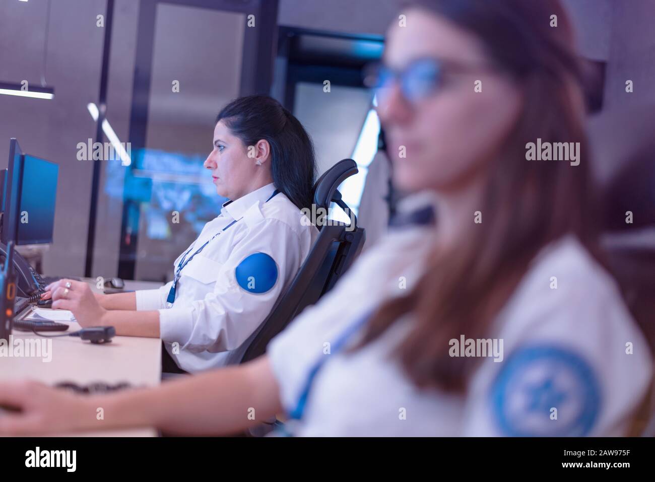 Security guard monitoring modern CCTV cameras in a surveillance room ...