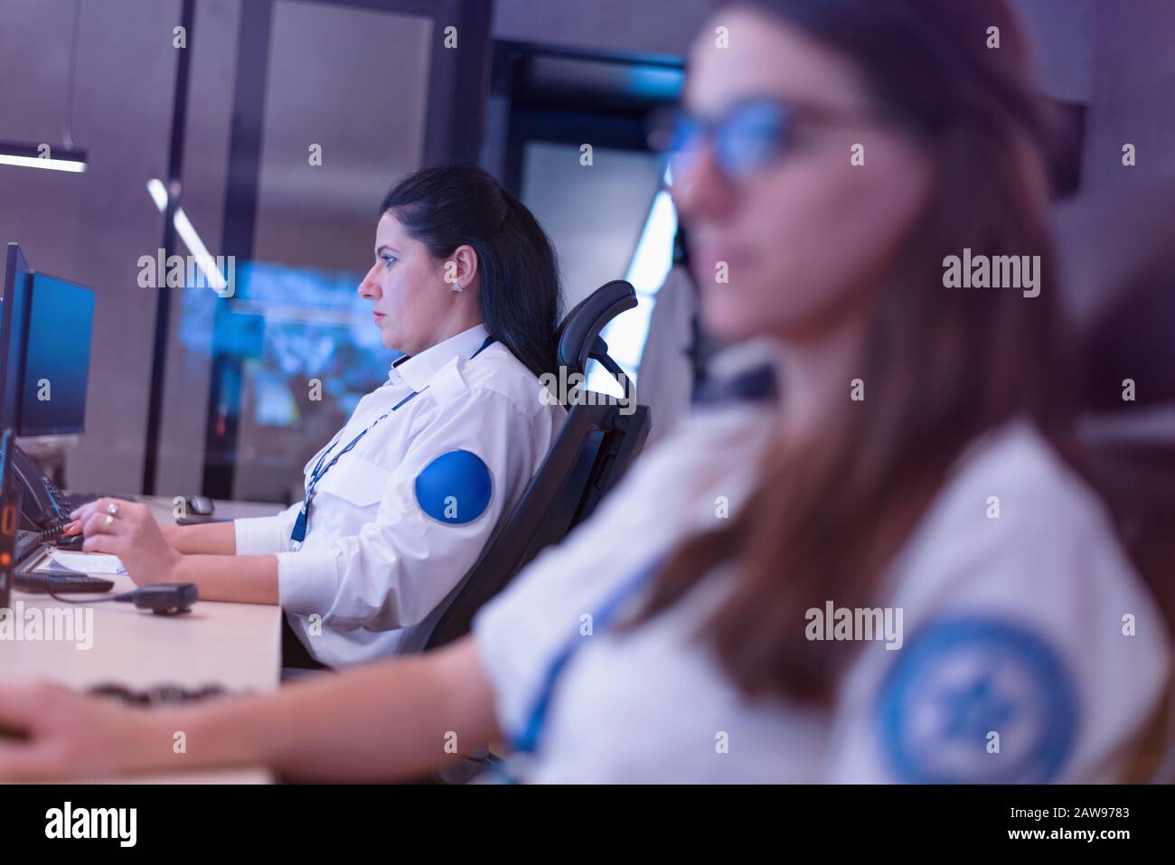 Security guard monitoring modern CCTV cameras in a surveillance room ...