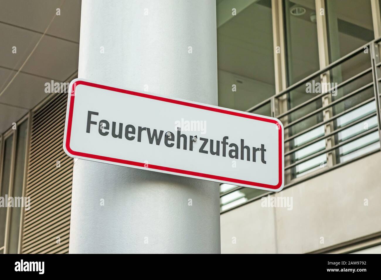 Sign labeled with Feuerwehrzufahrt (fire rescue path) on a pillar in ...