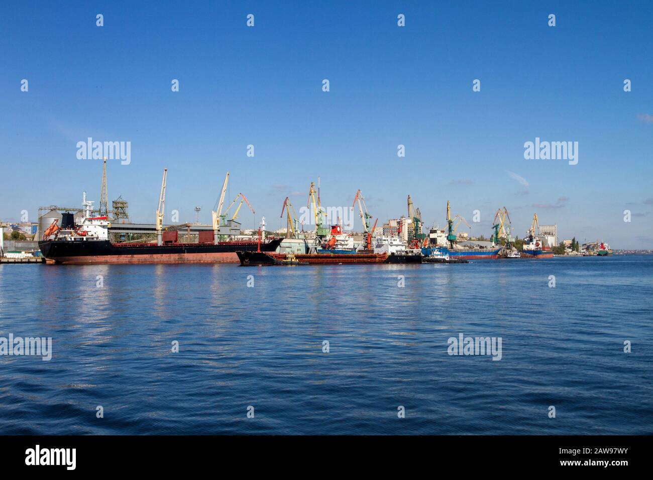 image of sea ships loading tower cranes in port Stock Photo - Alamy