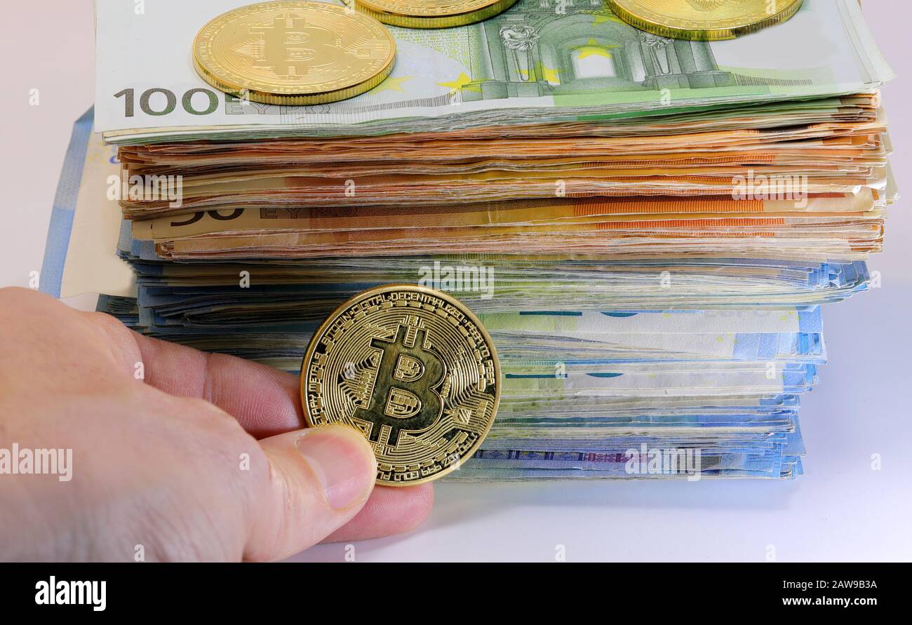 many money and bit coin on the hand Stock Photo - Alamy