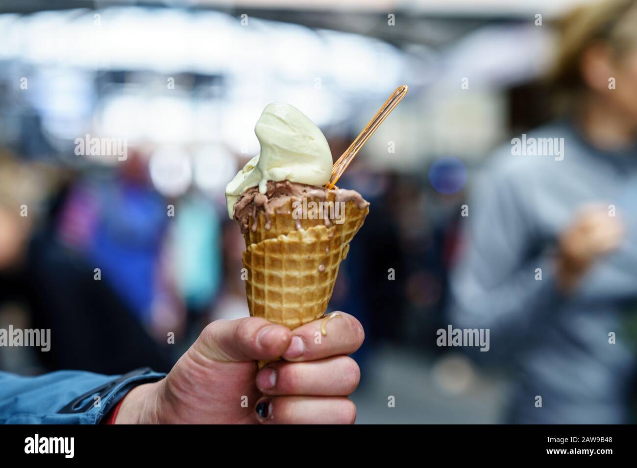 Man holding ice cream cone. Detail of ice cream in hand Stock Photo - Alamy