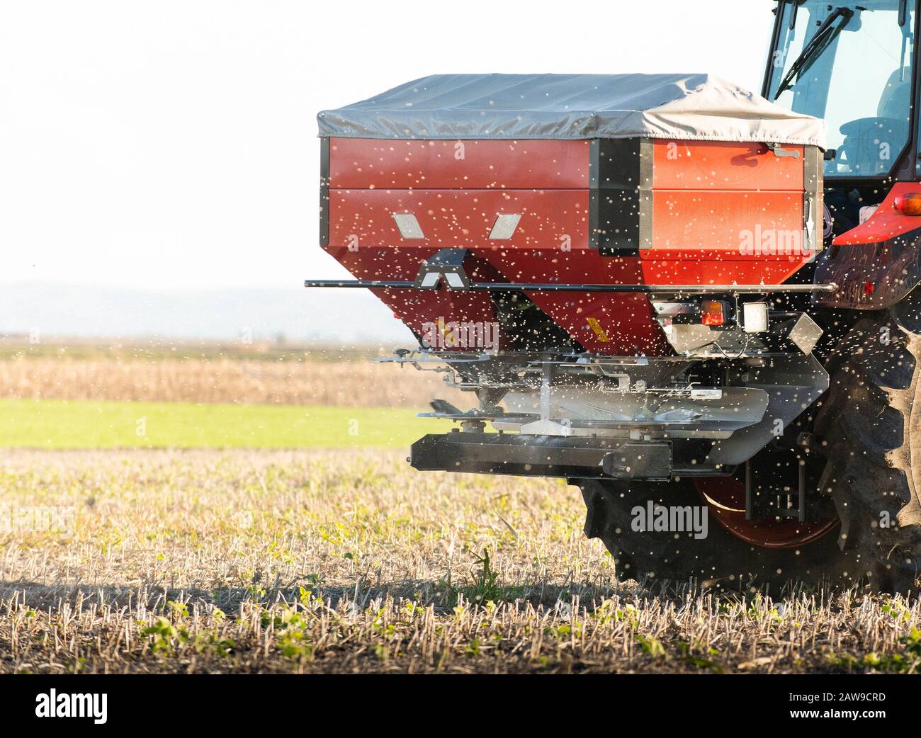 Tractor spreading artificial fertilizers in field Stock Photo - Alamy