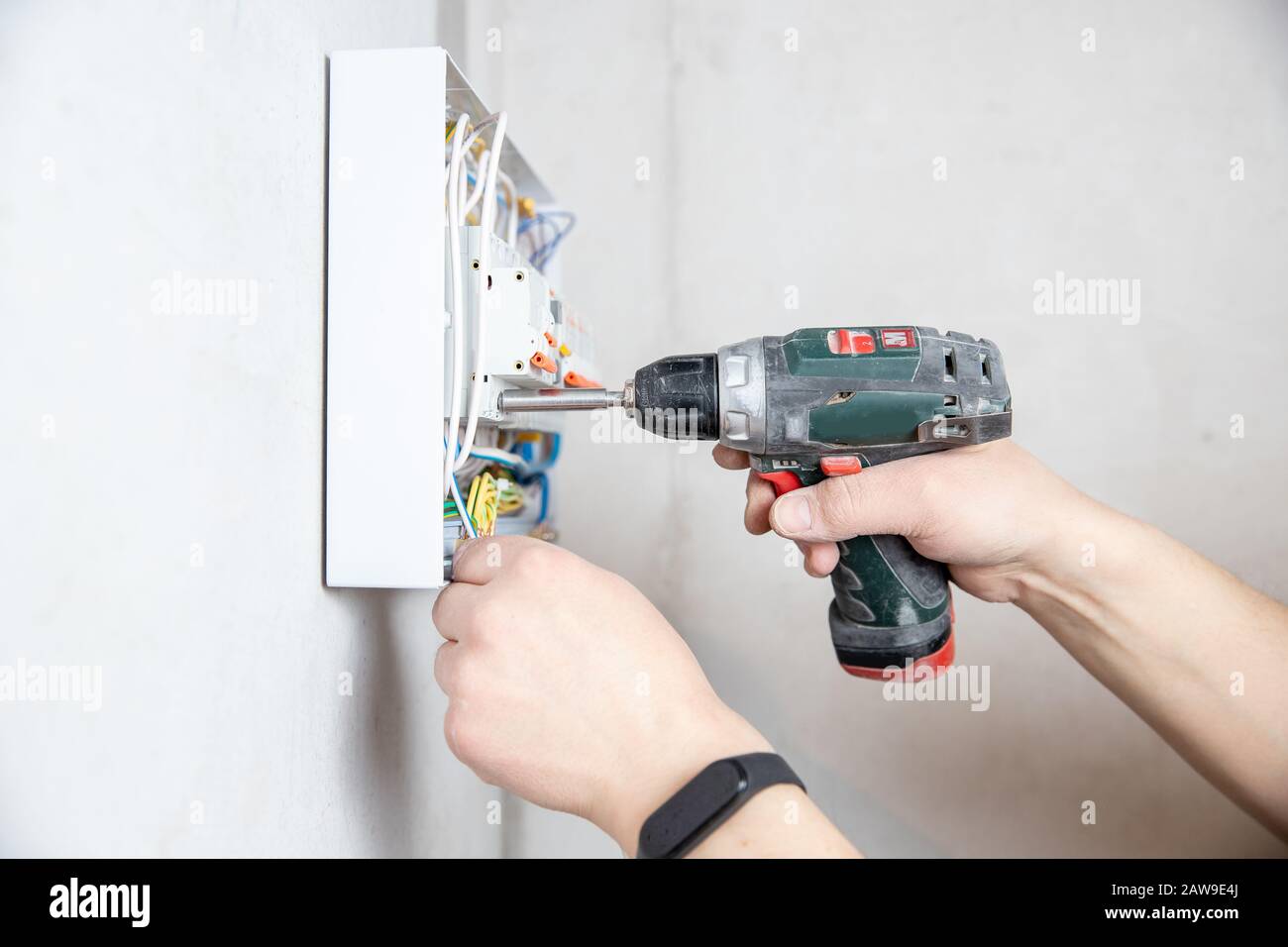 Electrician hand mounts consumer electric control panel switchboard for ...