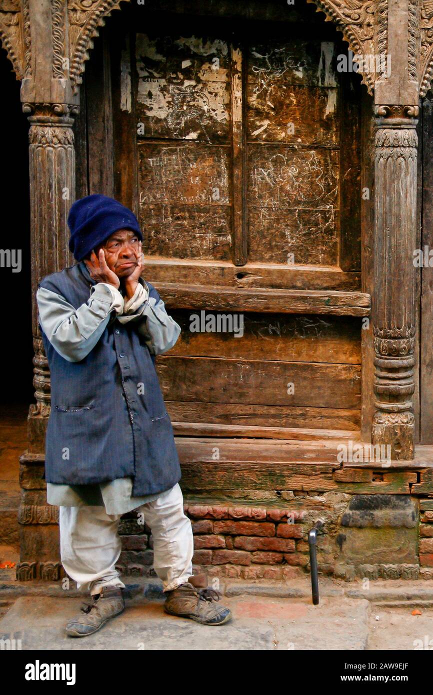 dwarf covering his ears in Nepal Stock Photo - Alamy