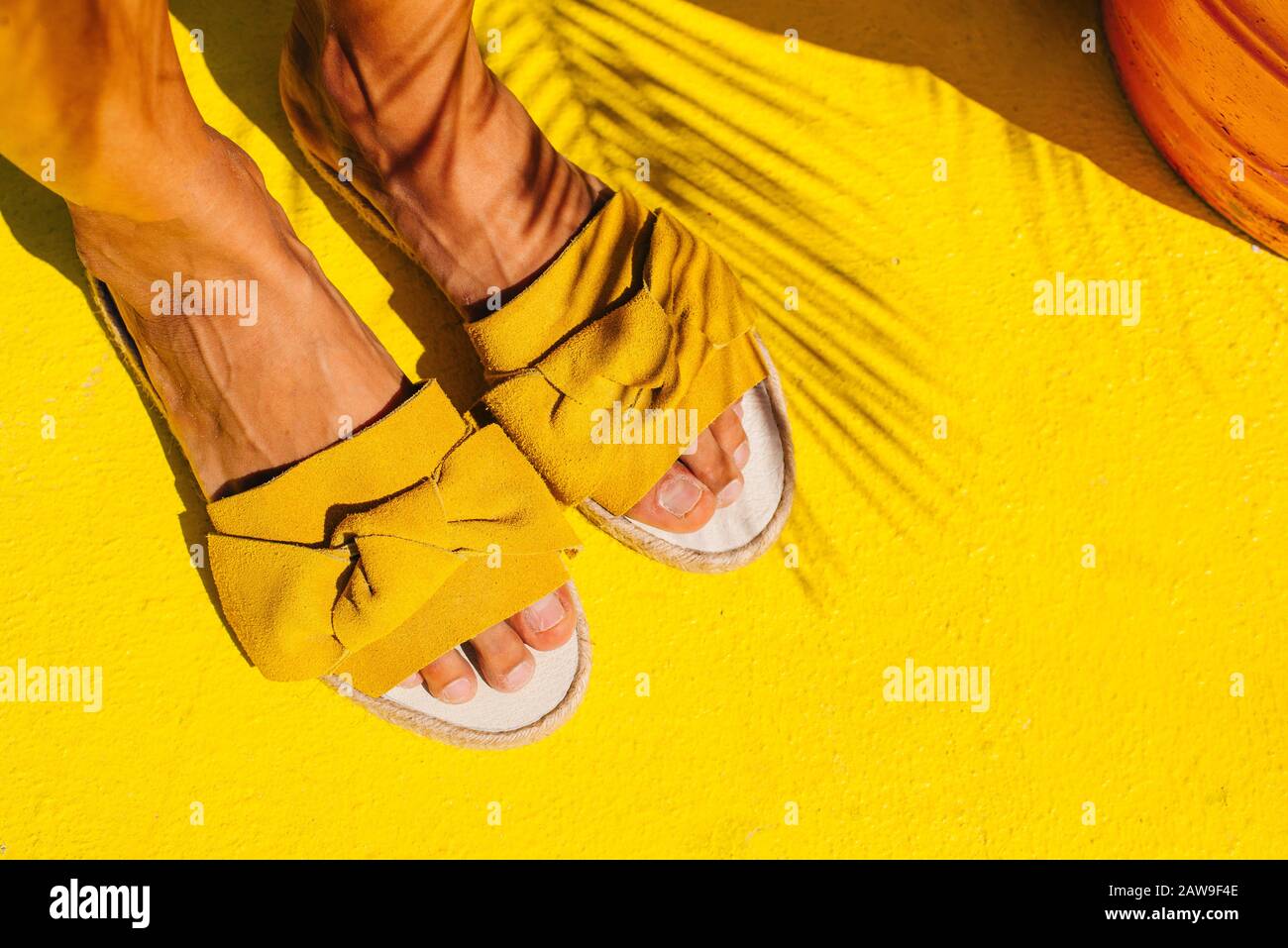 legs of a girl in yellow shoes on a yellow floor Stock Photo - Alamy