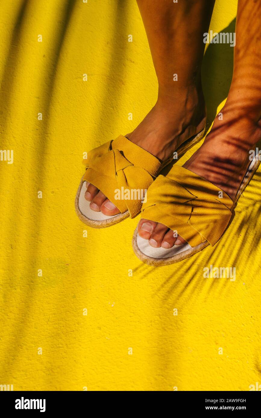 legs of a girl in yellow shoes on a yellow floor Stock Photo - Alamy