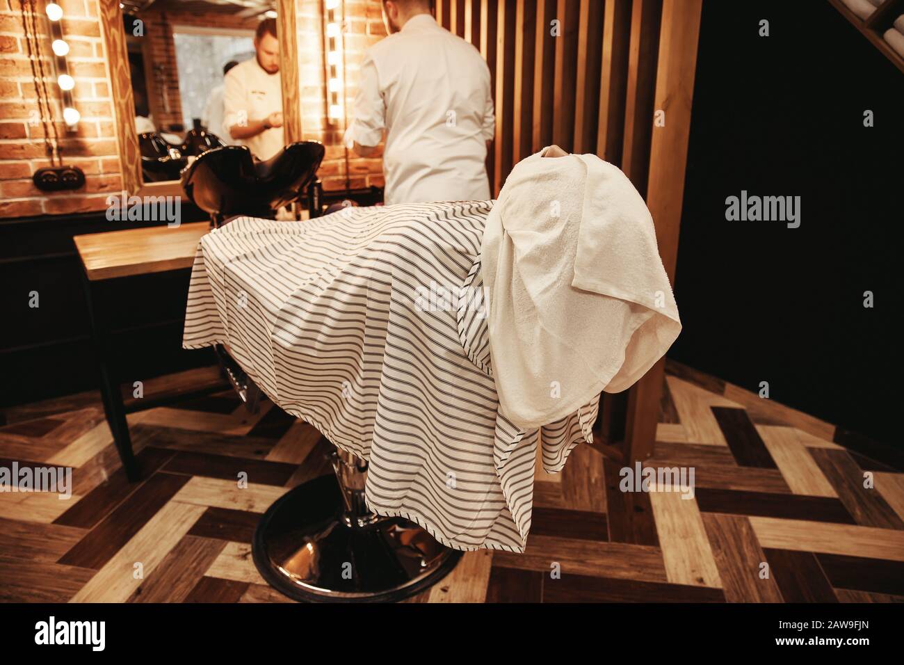 Barber shop, loft interior design, client man in hairdresser chair with ...