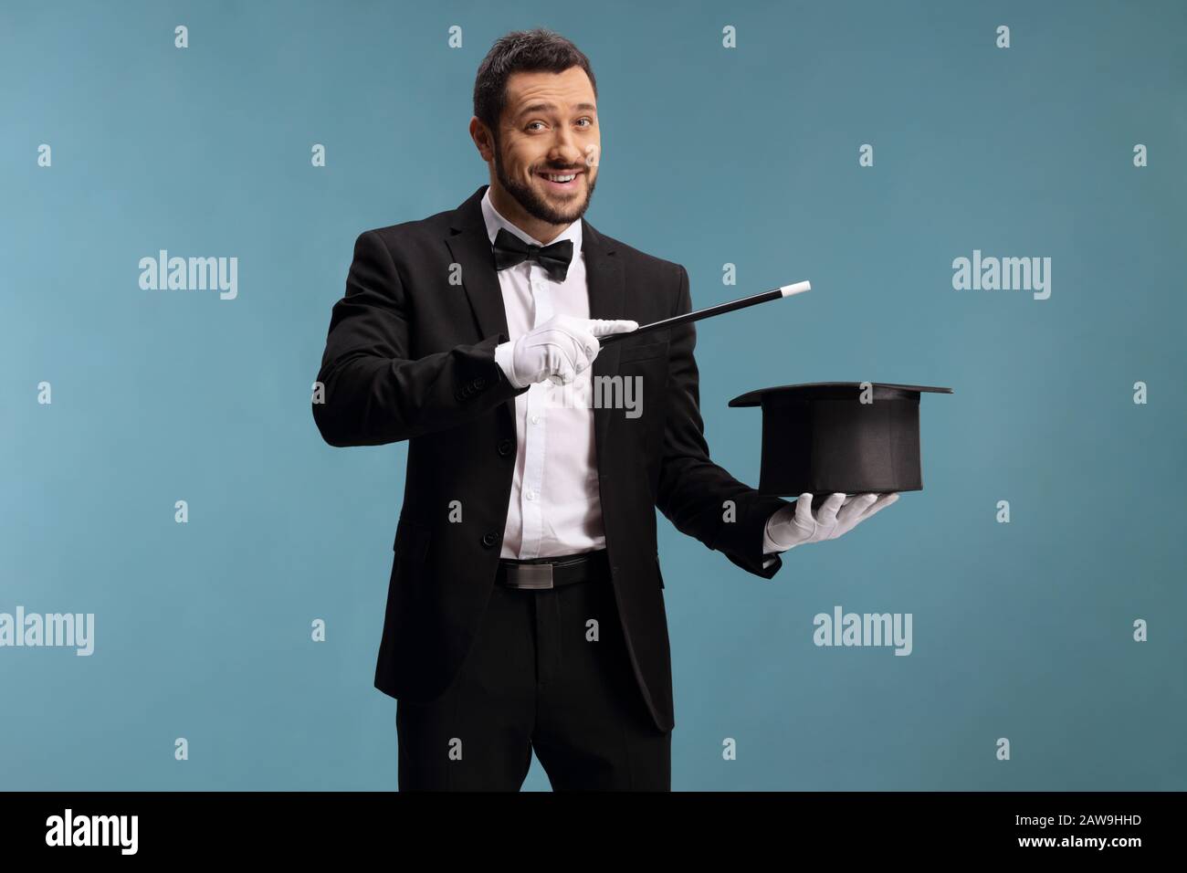 Magician with a wand and a hat isolated on blue background Stock Photo ...