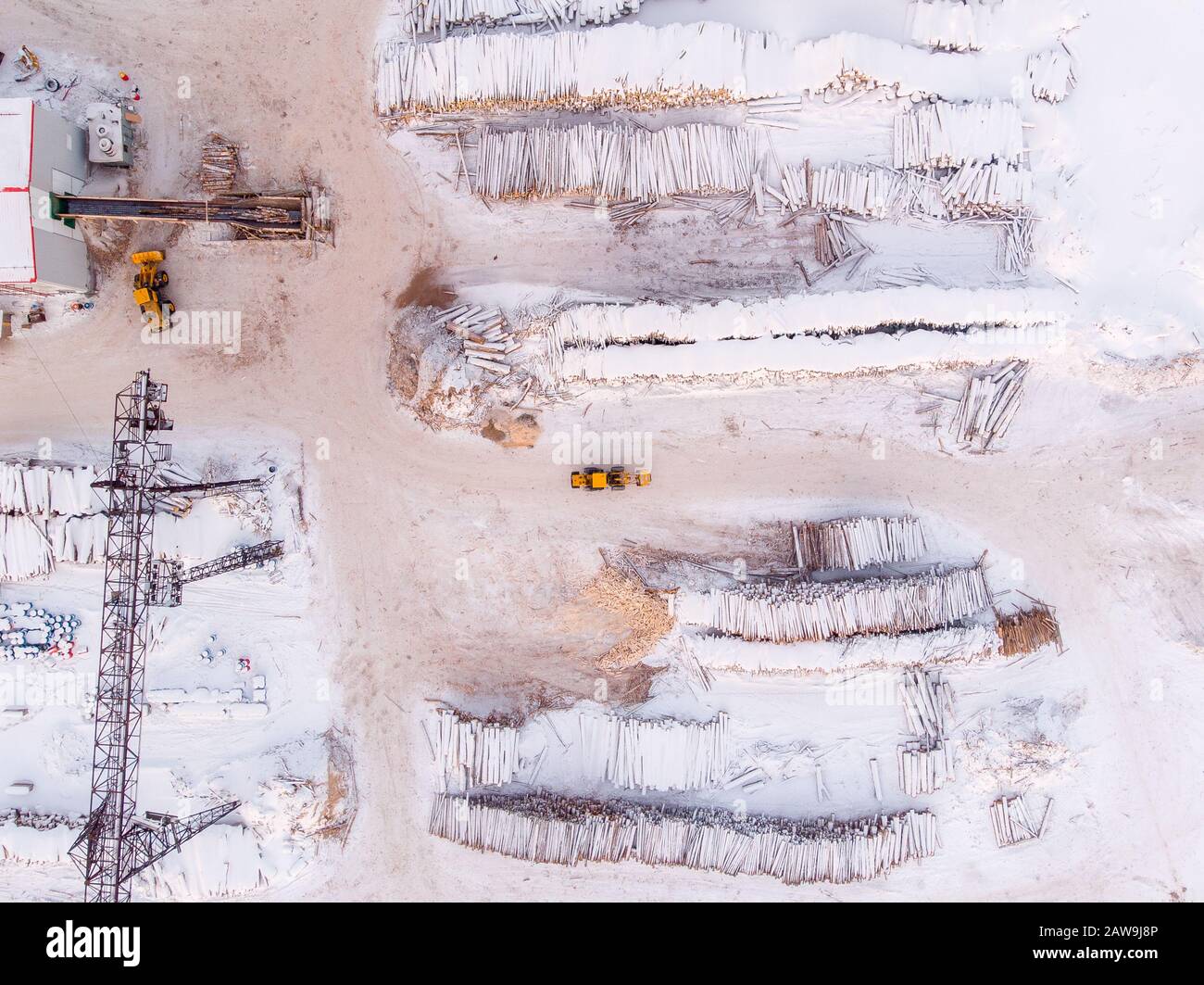 Industrial photo, storage of wooden logs under the snow at a sawmill ...