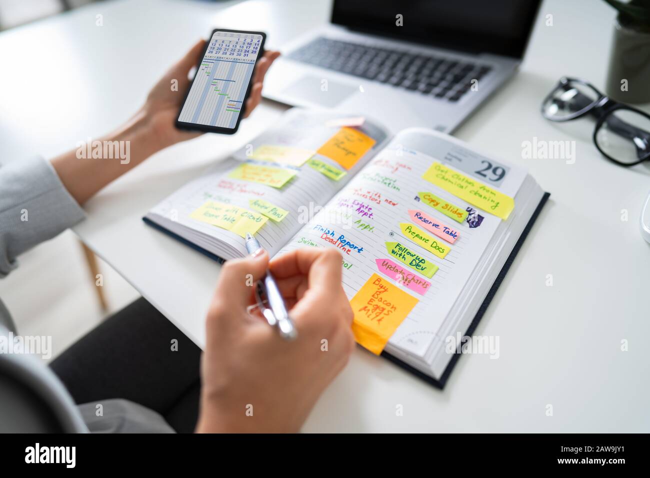 Person Hands With Mobile Phone And Diary Stock Photo - Alamy