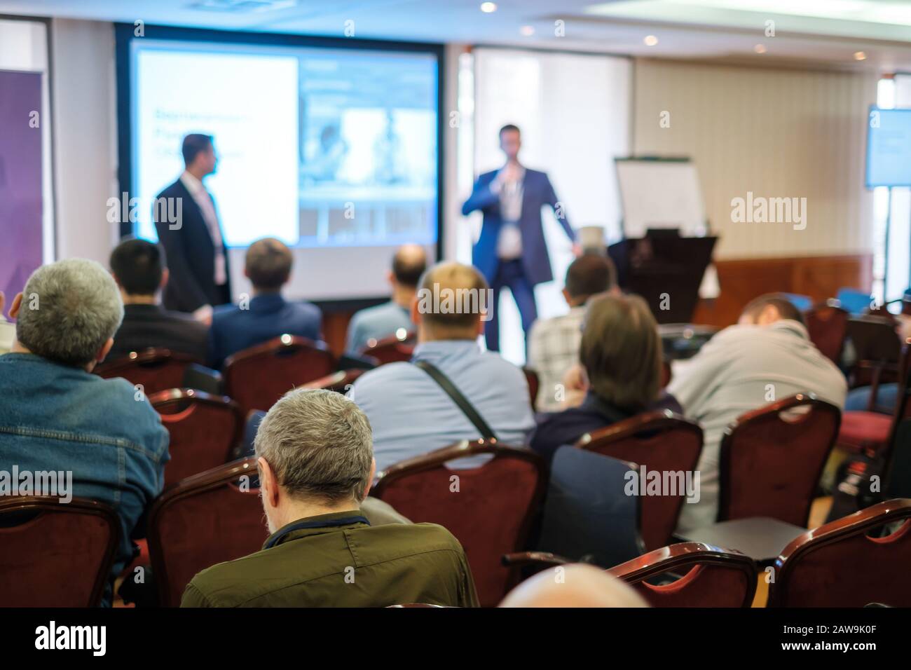 Business conference attendees sit and listen Stock Photo - Alamy