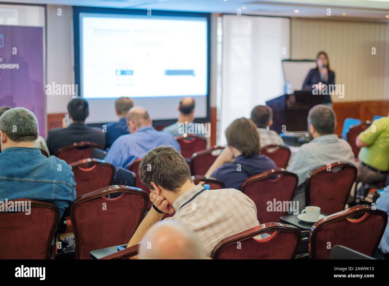 Business conference attendees sit and listen Stock Photo - Alamy