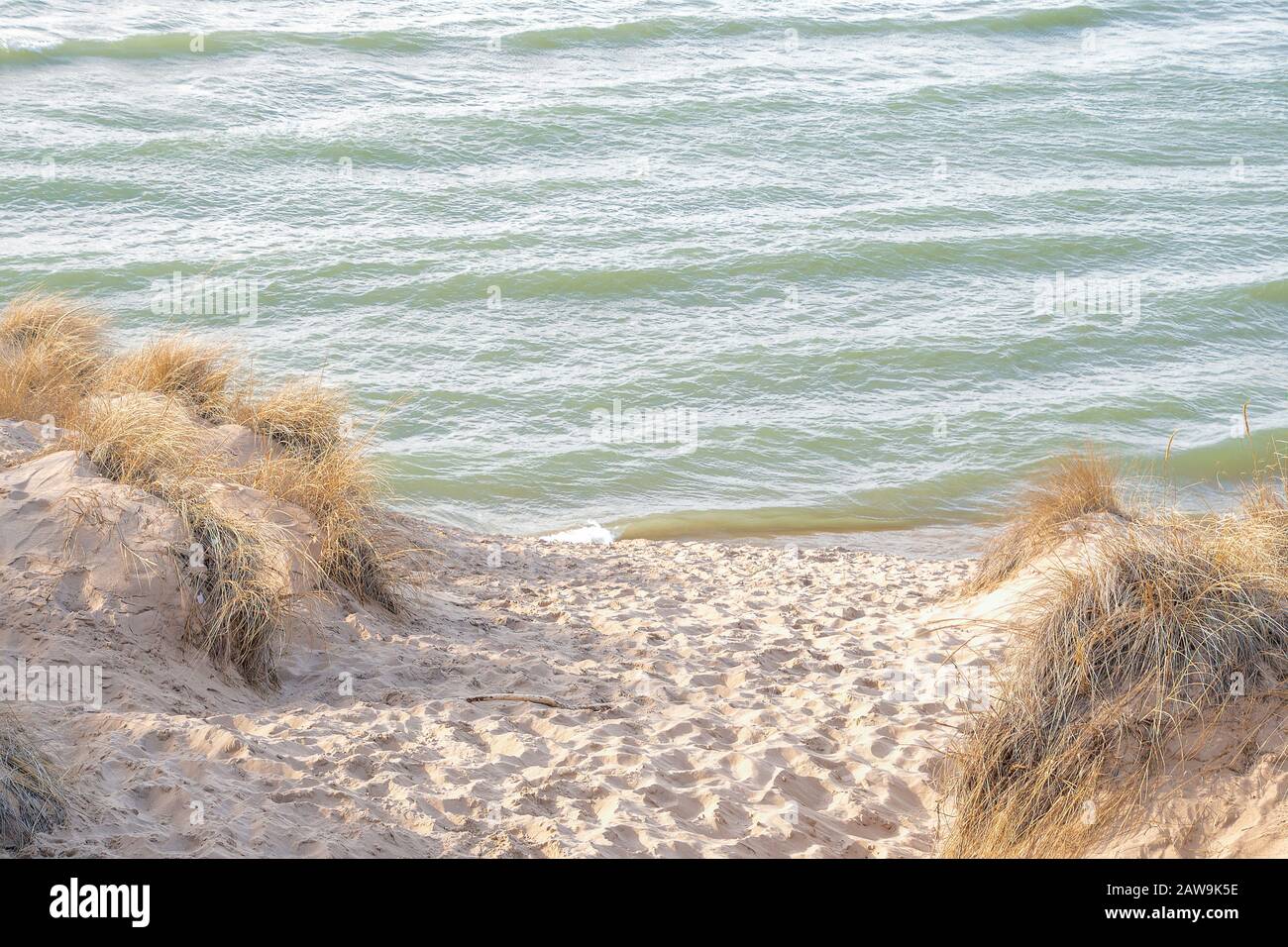 sandy beach path to lake water edge between sand dunes with grass Stock ...