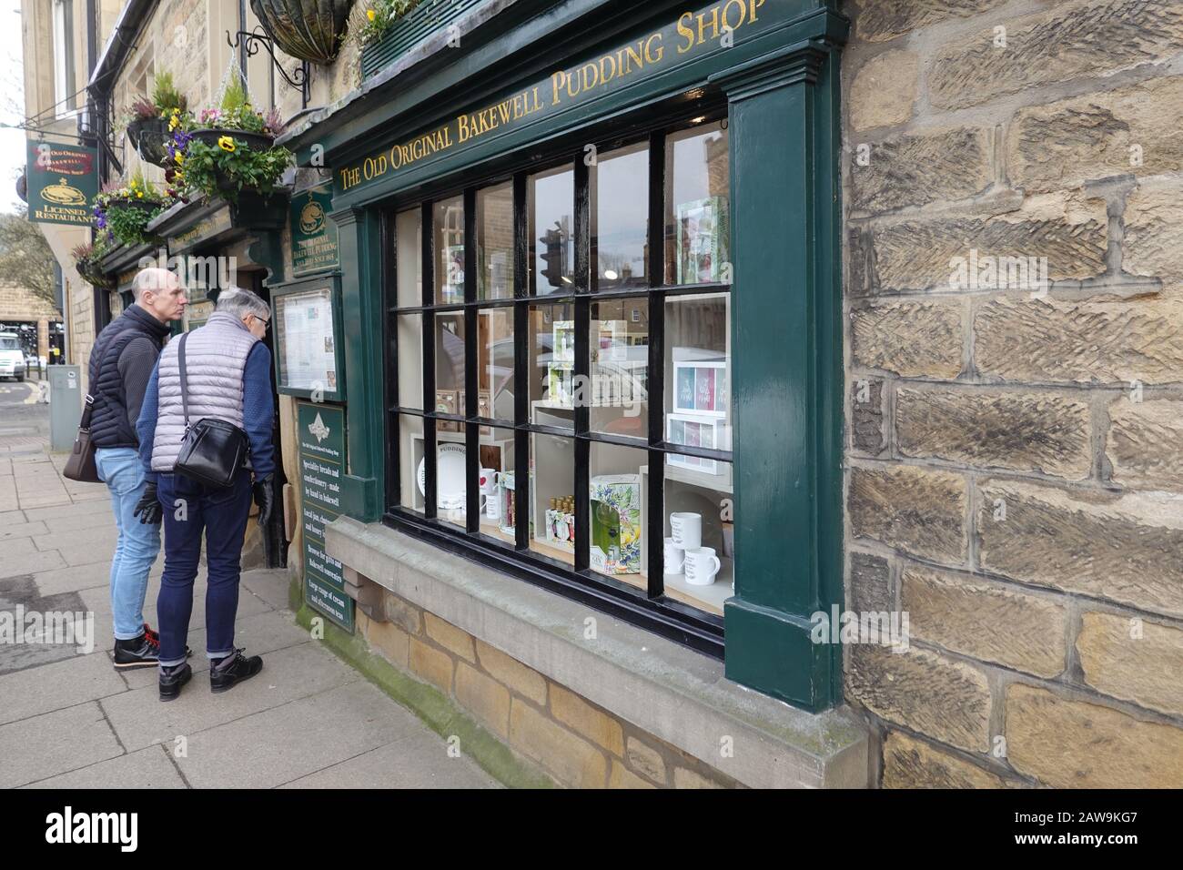 A couple look at the menu of The Original Bakewell Pudding Shop Stock ...