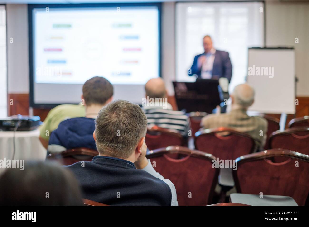 Business conference attendees sit and listen Stock Photo - Alamy