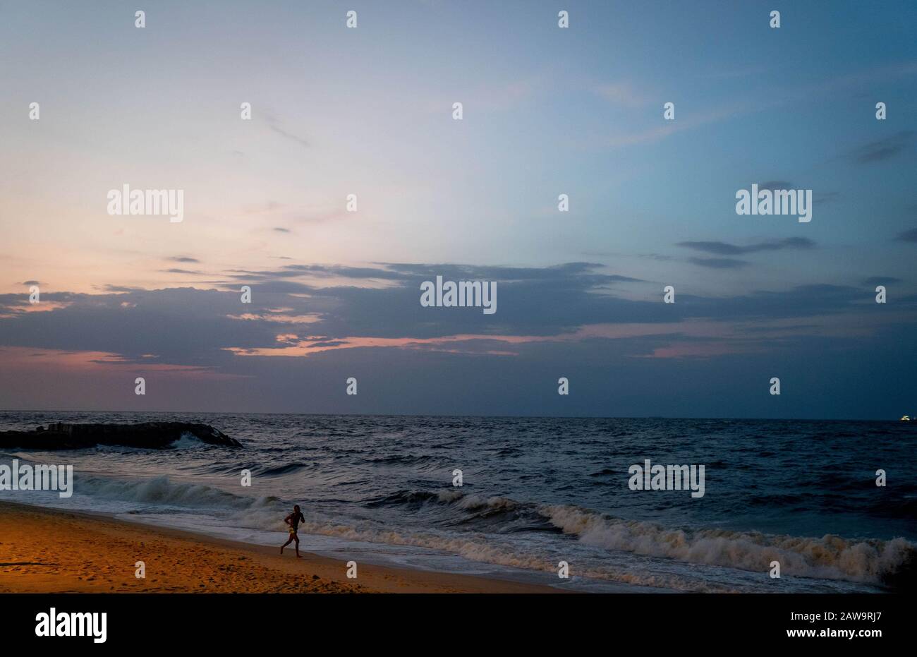 Luanda, Angola. 07th Feb, 2020. A jogger runs on the beach in front of ...