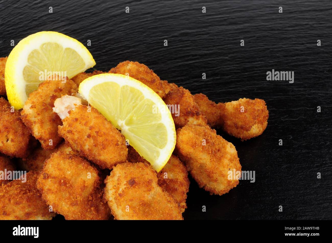 Crispy breadcrumb covered fried scampi on a slate background Stock ...