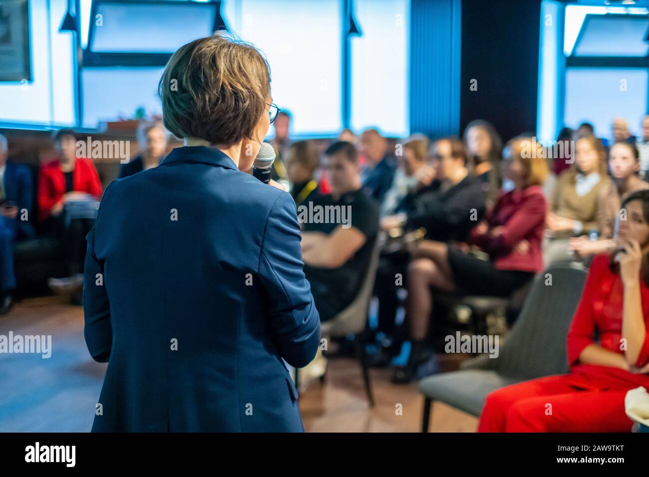 Female presenter speaks to audiences Stock Photo - Alamy