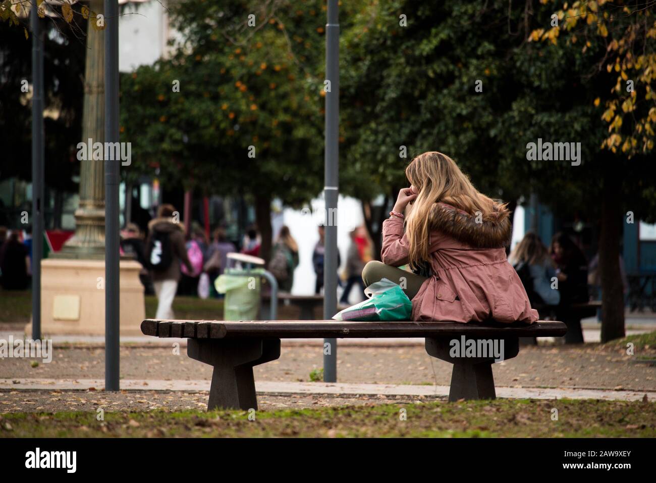Girl waiting boring in the bench of a park a cold day of winter Stock ...