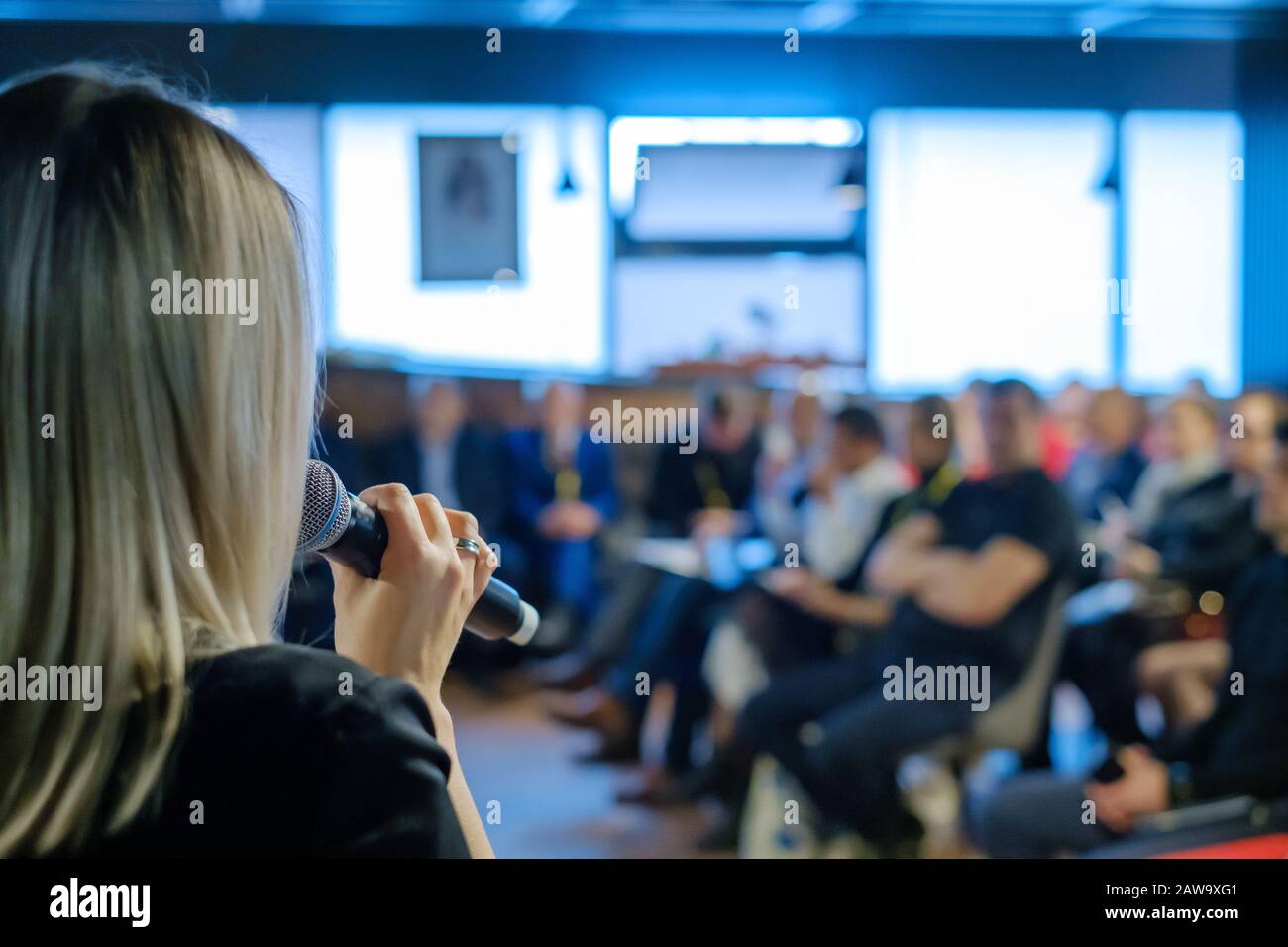 Female presenter speaks to audiences Stock Photo - Alamy