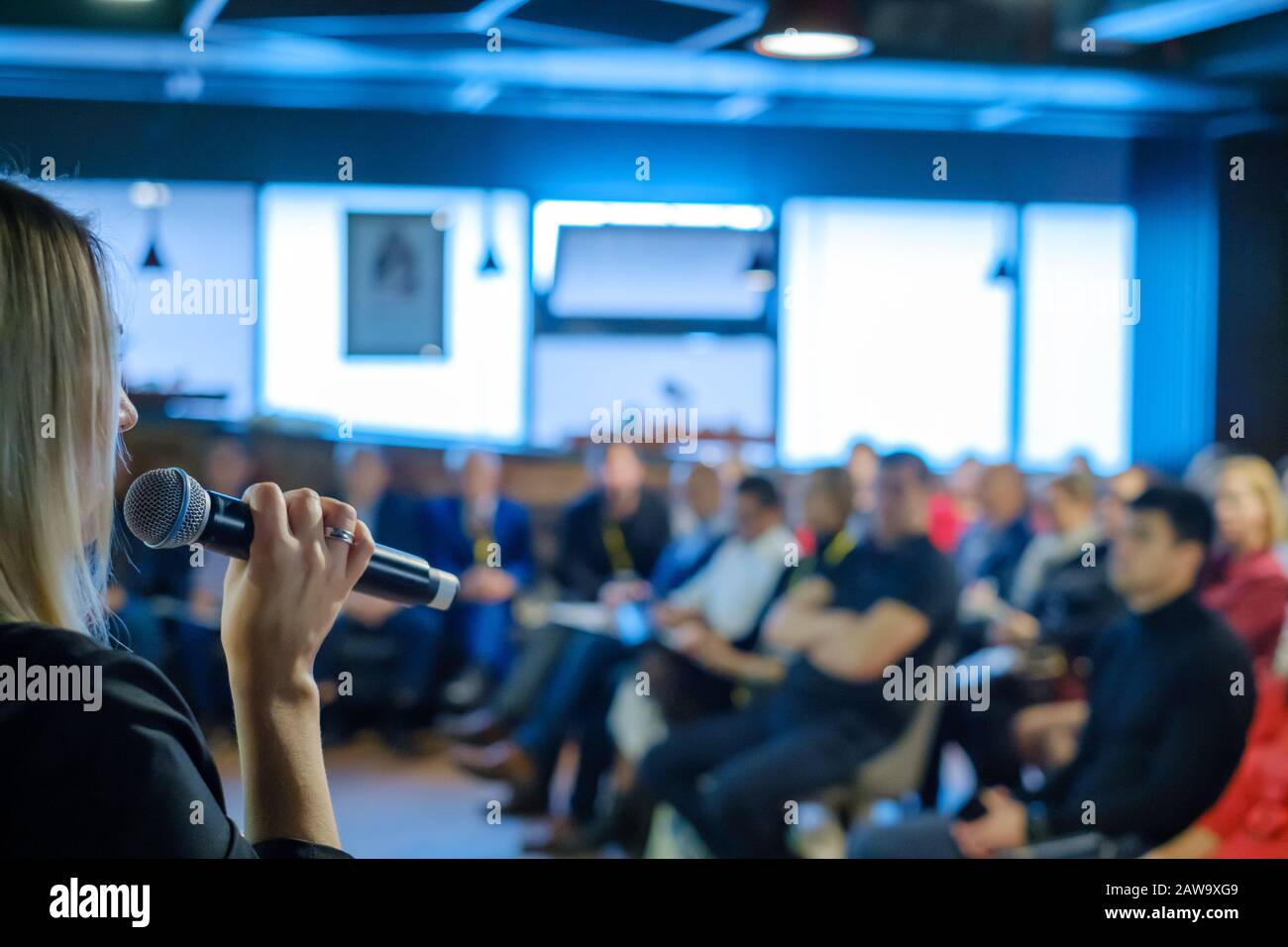 Female presenter speaks to audiences Stock Photo - Alamy