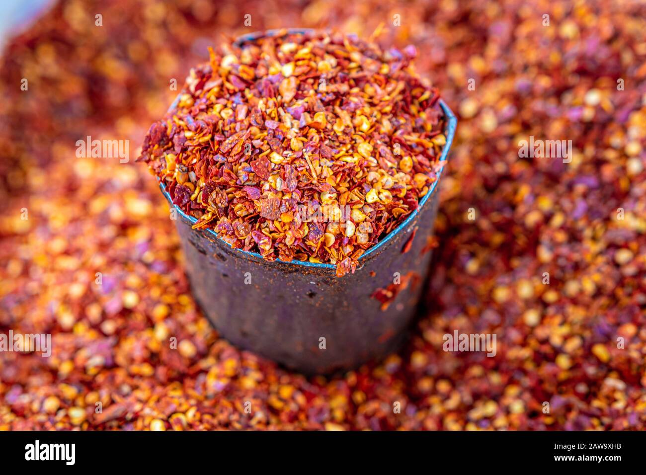 Red hot chili flakes in tin can, local fresh market Stock Photo - Alamy