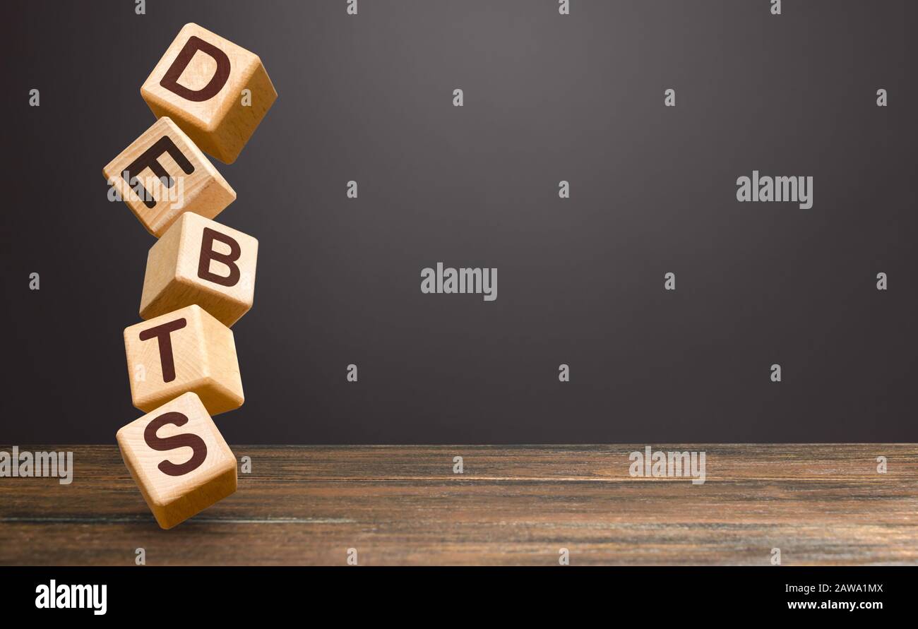 Unstable collapsing tower of blocks and the word Debts. Restructuring ...