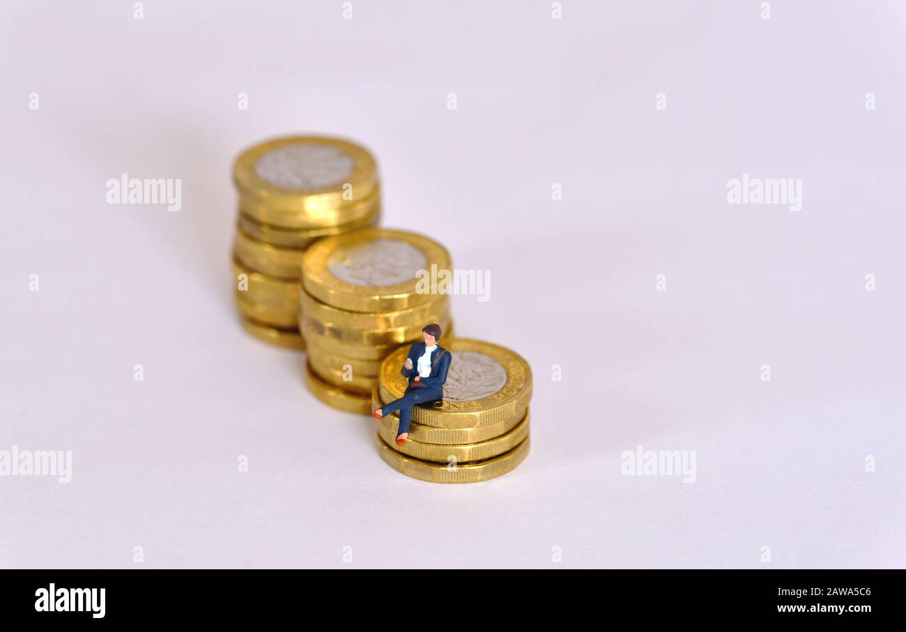 Model of young woman using mobile phone while sitting on a pile of one ...